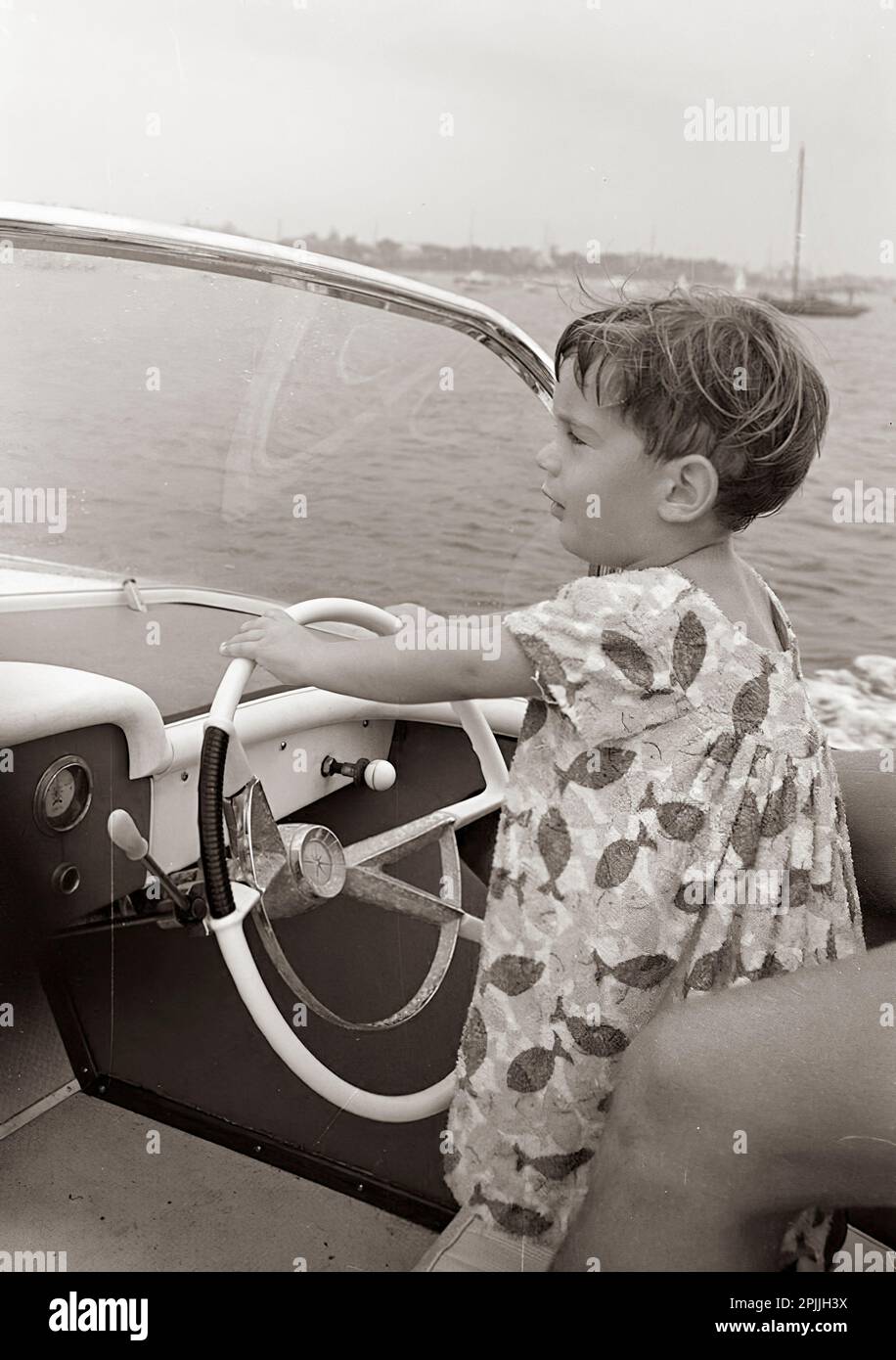 ST-C281-41-63 25 August 1963 John F. Kennedy, Jr. in Speedboat Near Hyannis Port [Scratches on ...