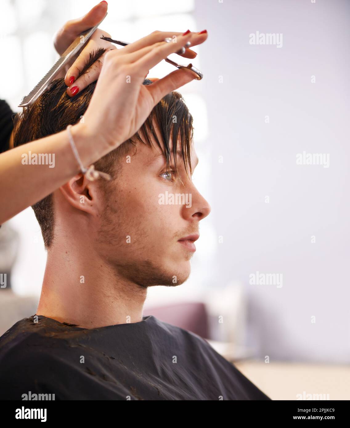 Trimmed to perfection. a man having his hair cut at a hair salon Stock ...