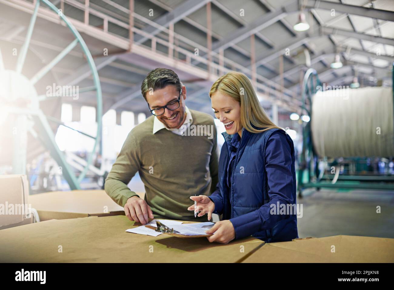 Running through inventory on the factory floor. a two managers reading ...