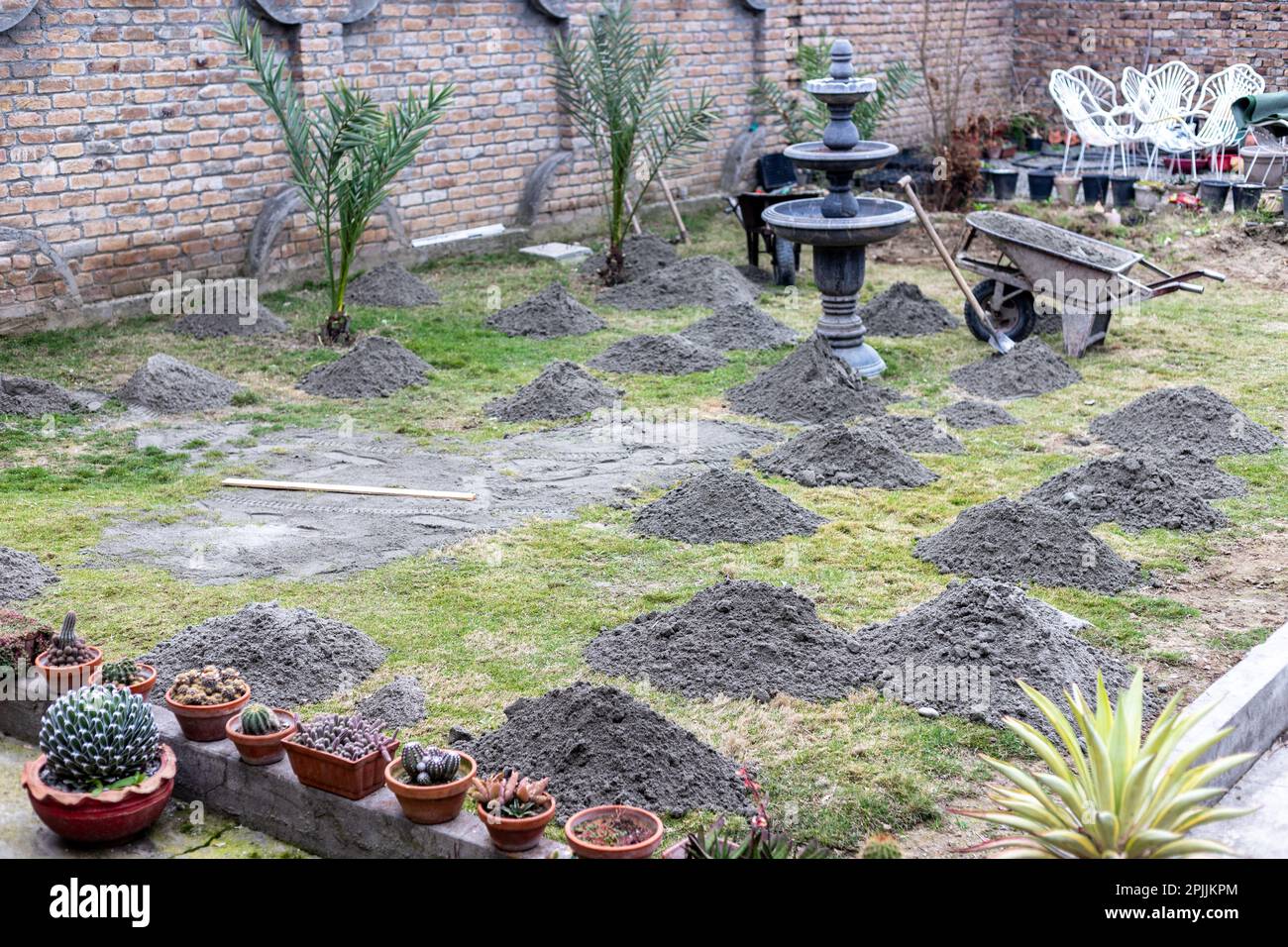 Leveling lawn with a river sand Stock Photo - Alamy