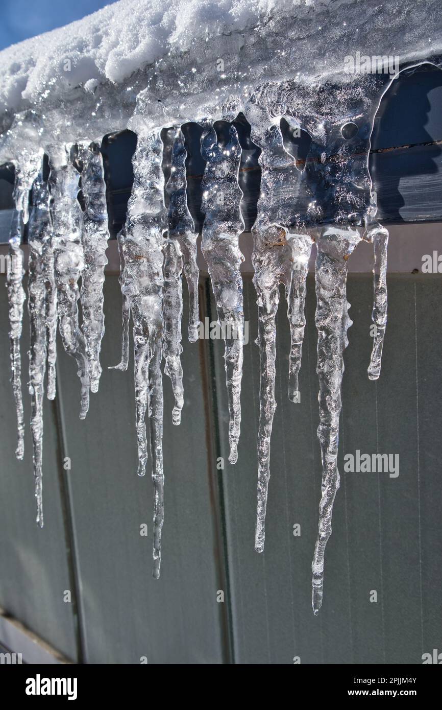 clear icicles dripping water from eaves at springtime Stock Photo - Alamy