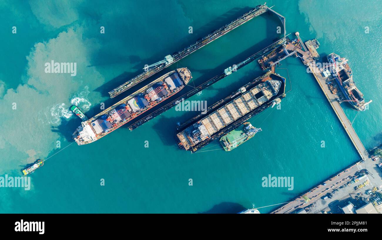 Tug boat Draging cargo container ship to dry dock concept maintenance ...