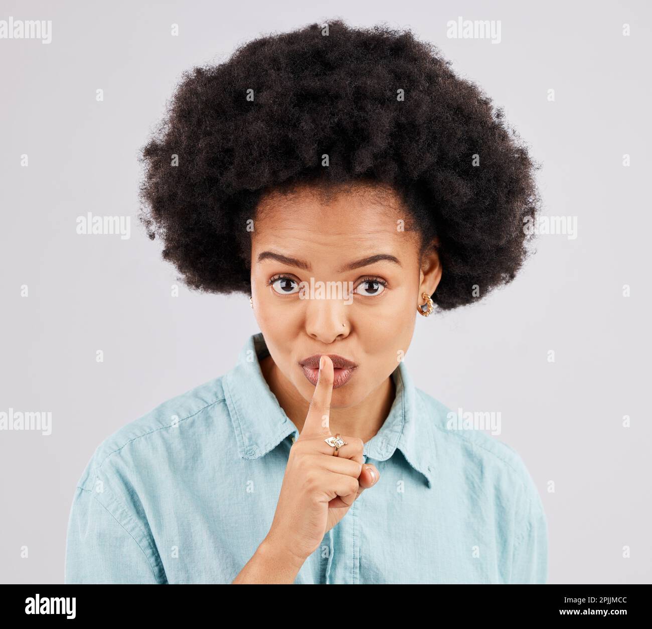 Secret, portrait and woman with finger on lips in studio, white ...