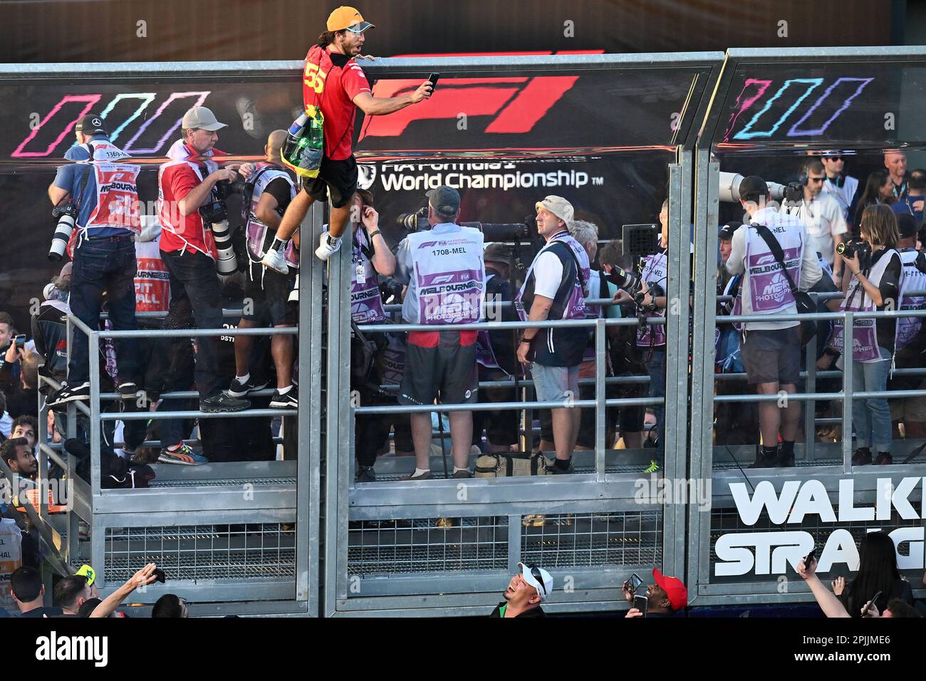 Spectators are seen climbing on fences as Max Verstappen of Red Bull ...