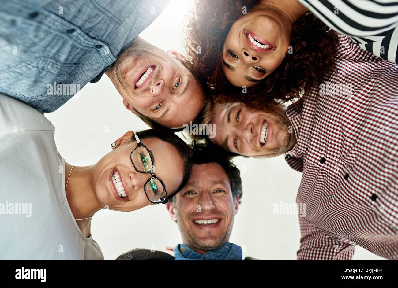 Putting their heads together. Low angle portrait of a group of ...