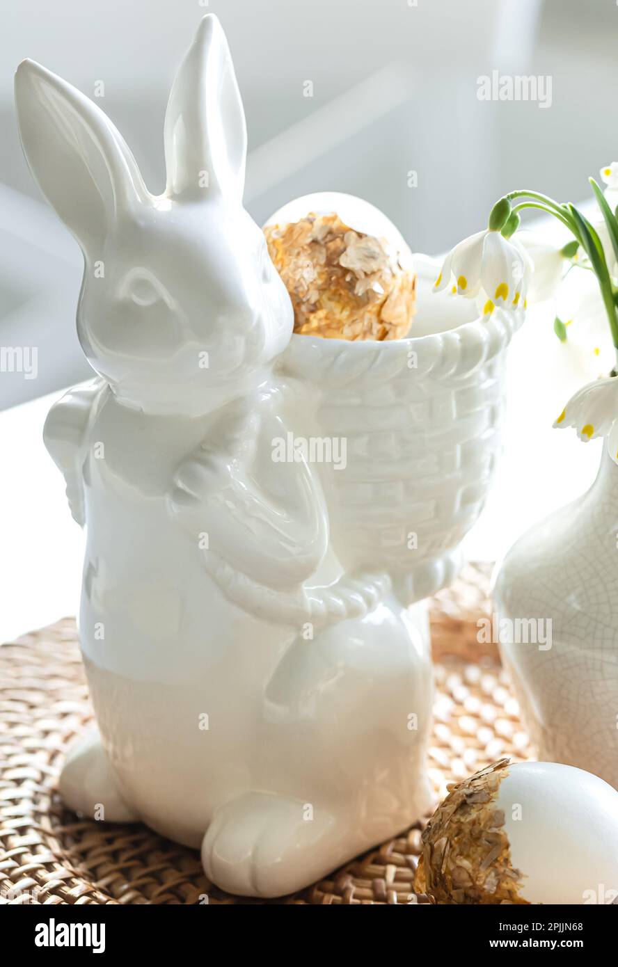 Easter still life with a ceramic hare, eggs and flowers Stock Photo - Alamy