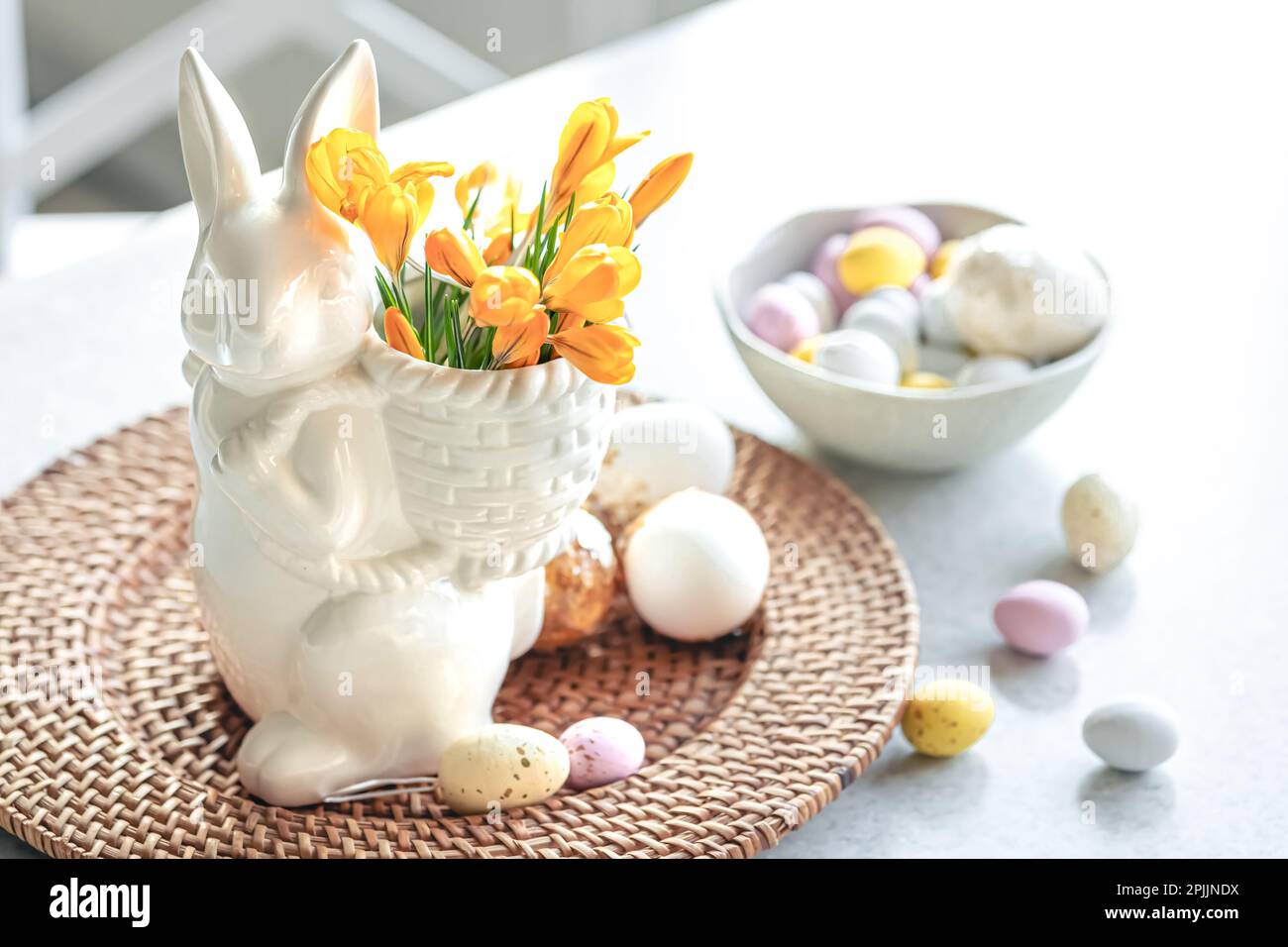 Easter still life with a ceramic hare, eggs and flowers Stock Photo - Alamy