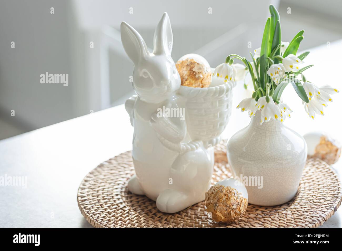 Easter still life with a ceramic hare, eggs and flowers Stock Photo - Alamy