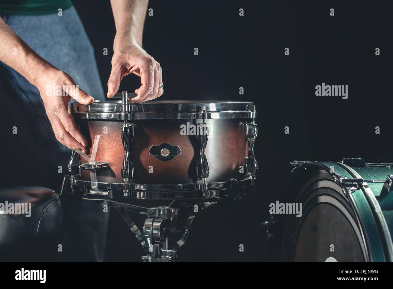 A man plays the snare drum against a dark background Stock Photo - Alamy