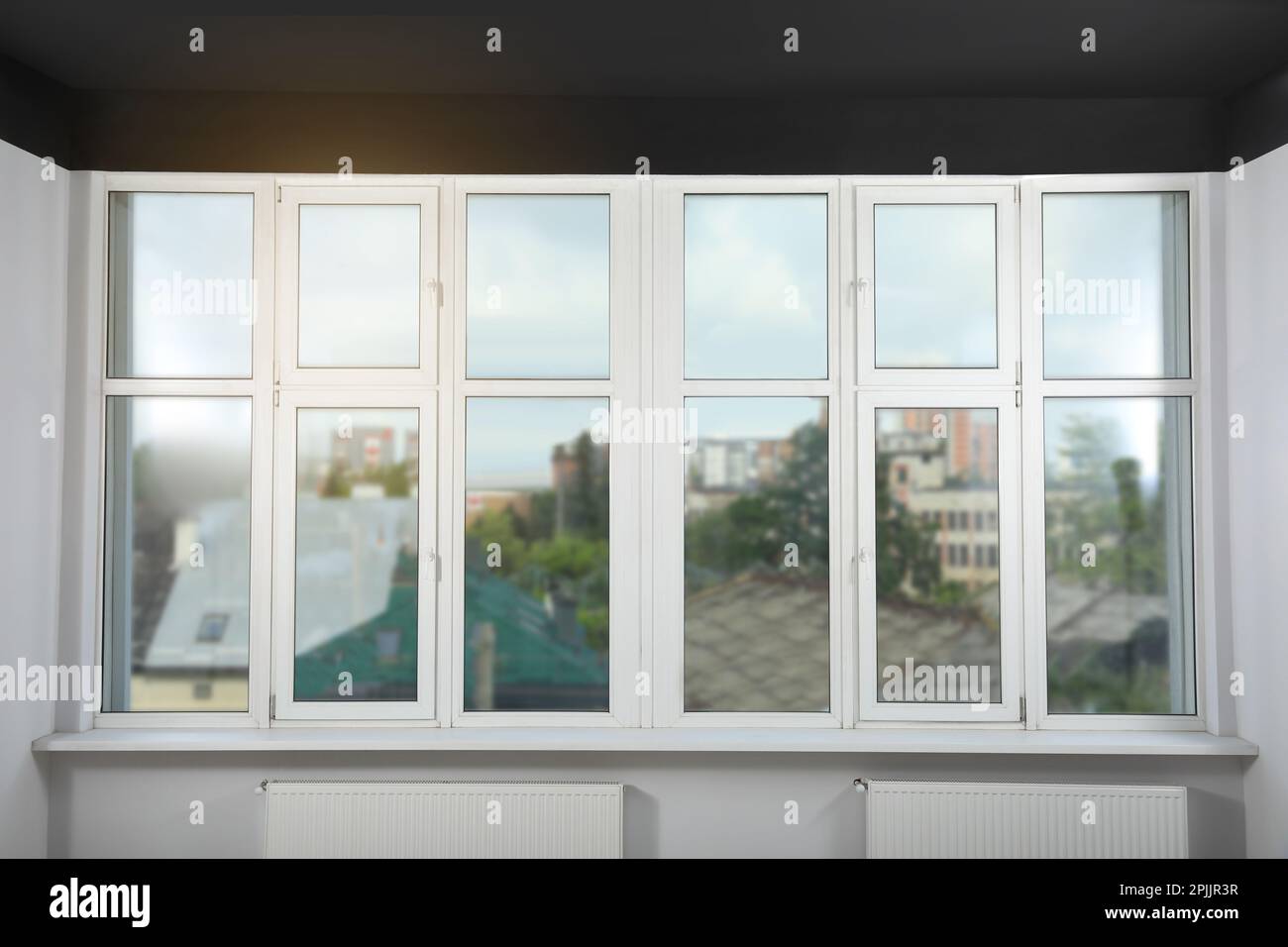 Beautiful view of cityscape through white windows Stock Photo - Alamy