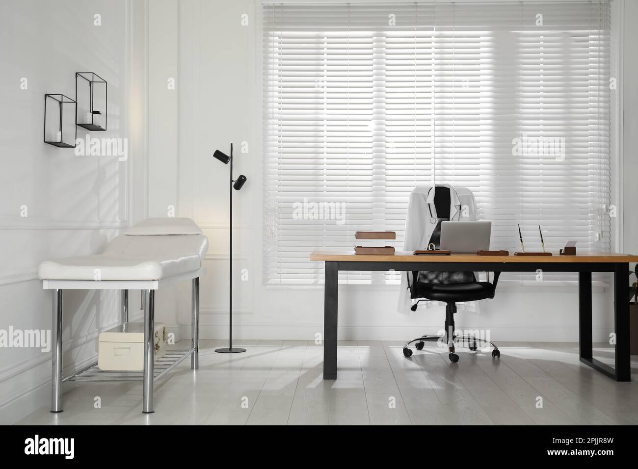 Modern medical office interior with doctor's workplace and examination ...