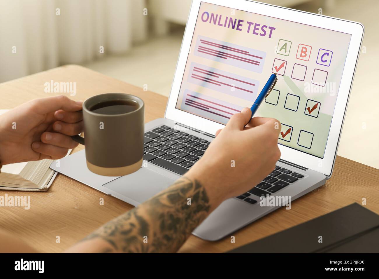 Hand taking exam on desk hi-res stock photography and images - Alamy