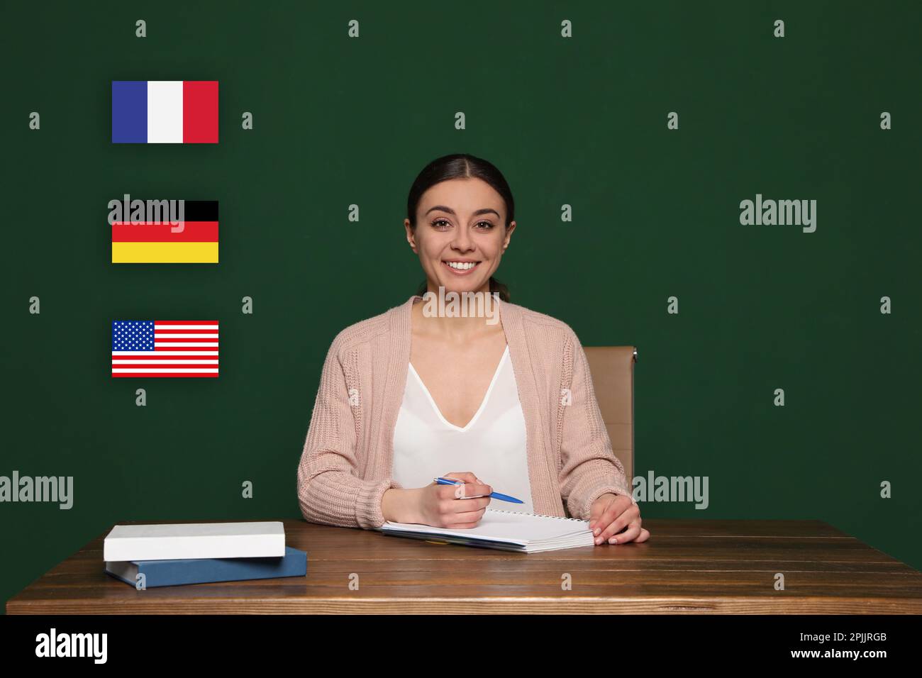 Portrait of foreign languages teacher at wooden table and different flags green chalkboard Stock ...