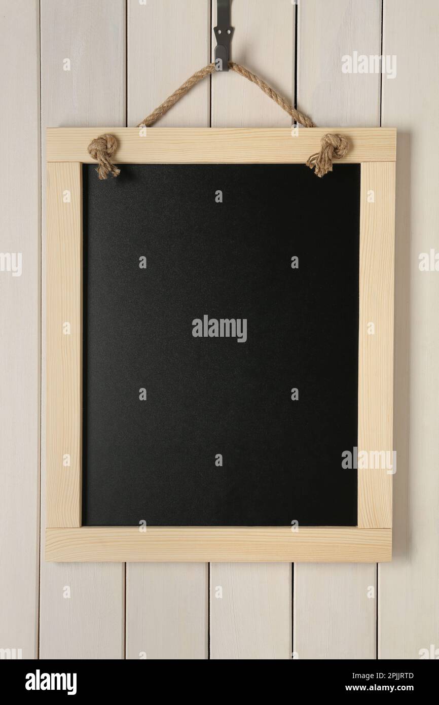 Clean small black chalkboard hanging on white wooden wall Stock Photo ...