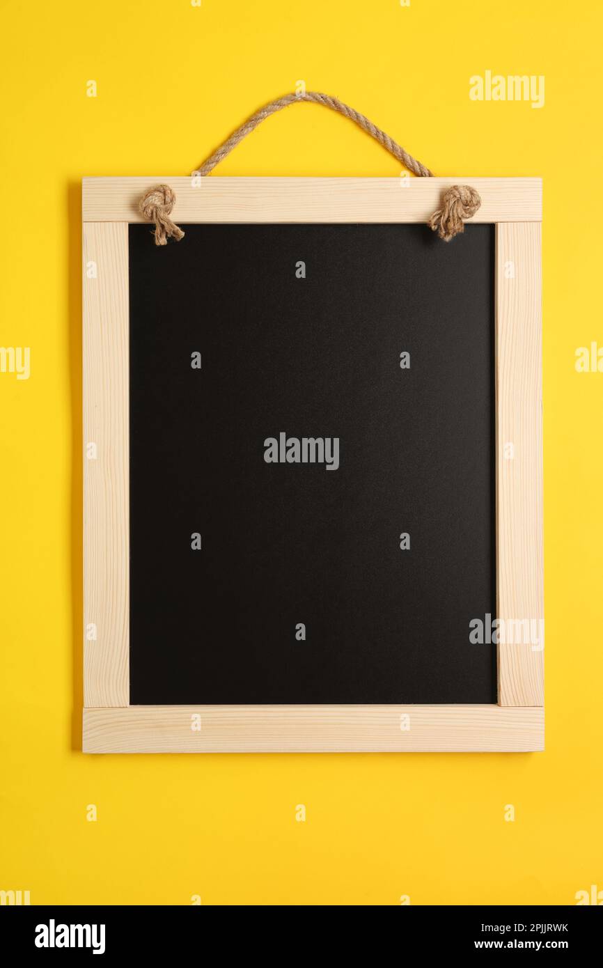 Clean small black chalkboard on yellow background, top view Stock Photo ...