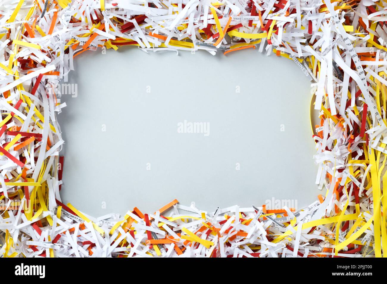 Frame of shredded colorful paper strips on white background, flat lay ...