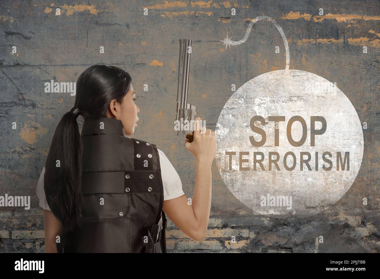 Rear view of a businesswoman holding gun with a stop terrorism sign on ...