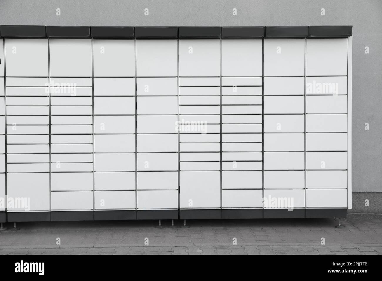 Modern parcel locker with many postal boxes outdoors Stock Photo - Alamy