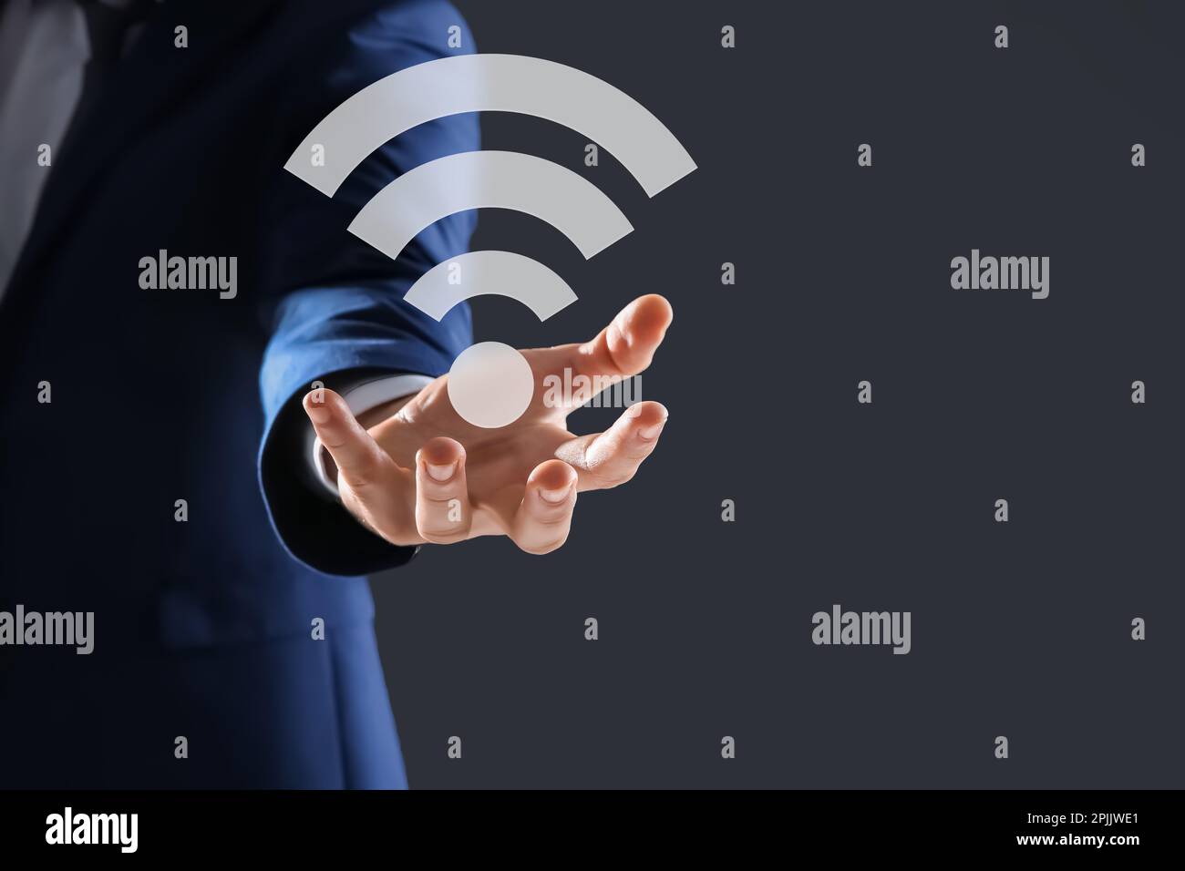 Man holding Wi Fi symbol in hand on dark grey background, closeup Stock ...