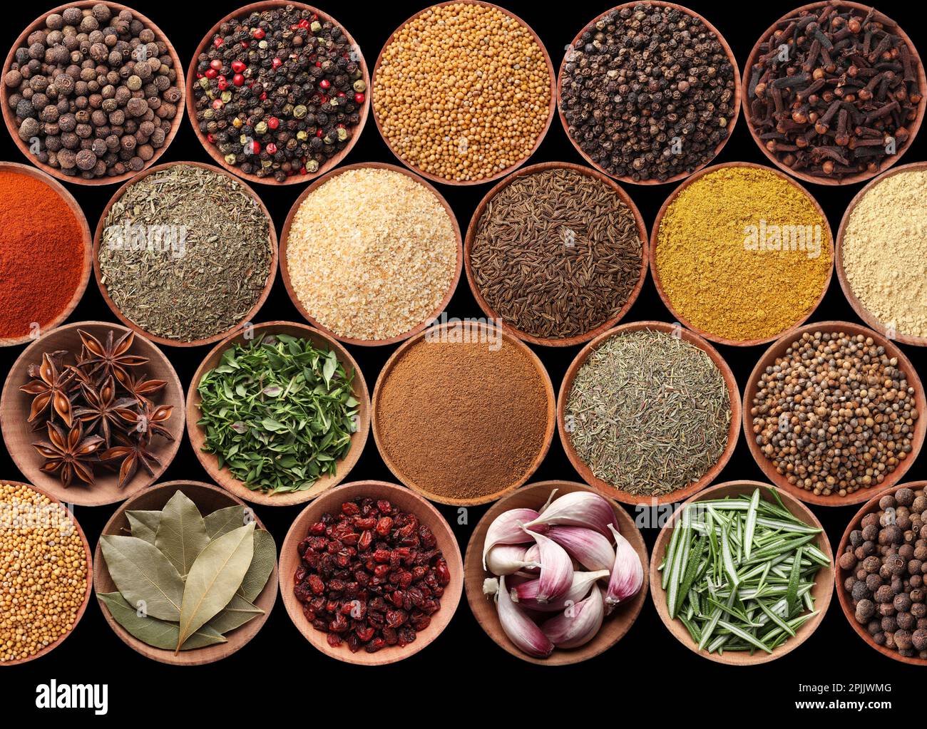 Collection of different aromatic spices and herbs on black background ...