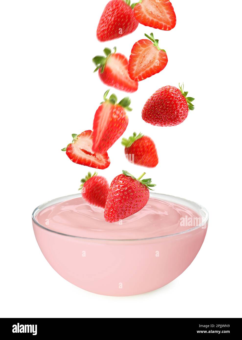 Many fresh red strawberries falling into glass bowl of yogurt on white background Stock Photo ...