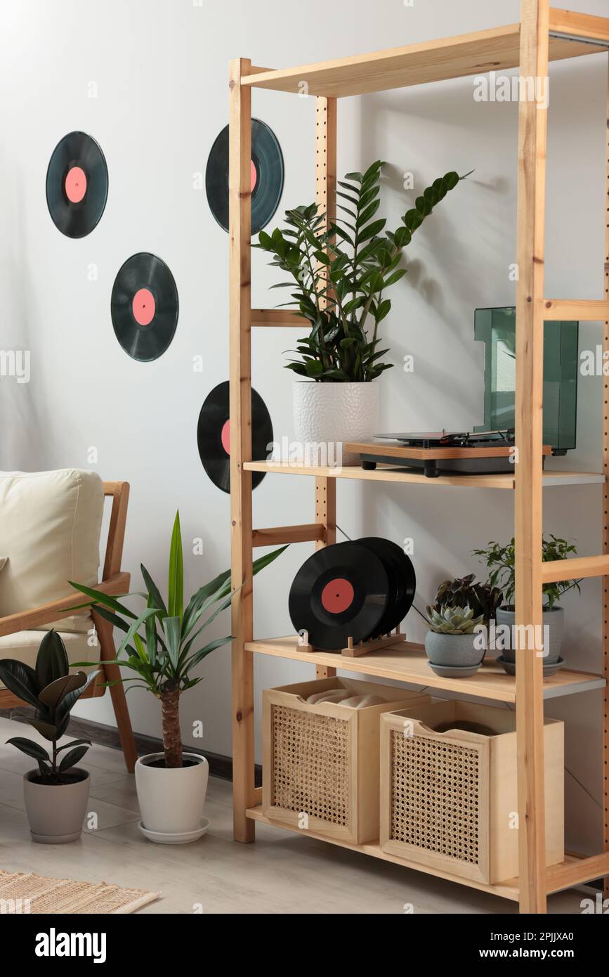 Living room interior with stylish turntable on wooden shelving unit and ...