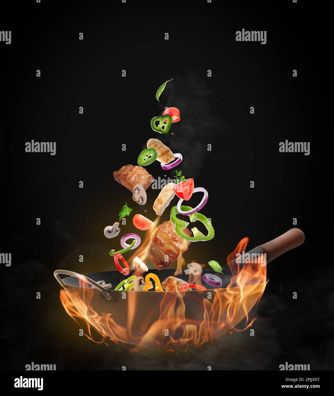 Wok with tasty ingredients and fire on black background Stock Photo - Alamy