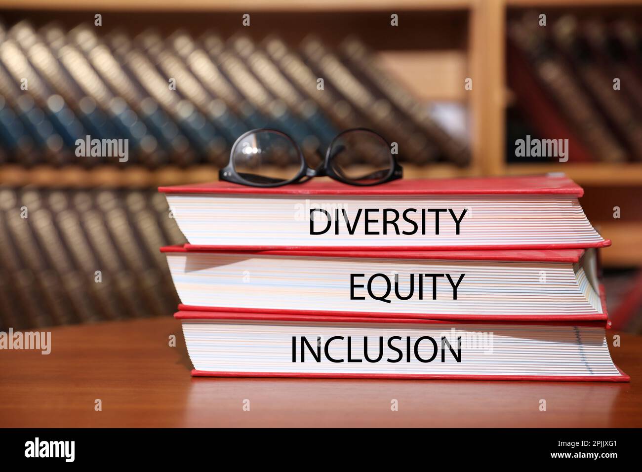 Stack of books with words Diversity, Equity, Inclusion and glasses on ...