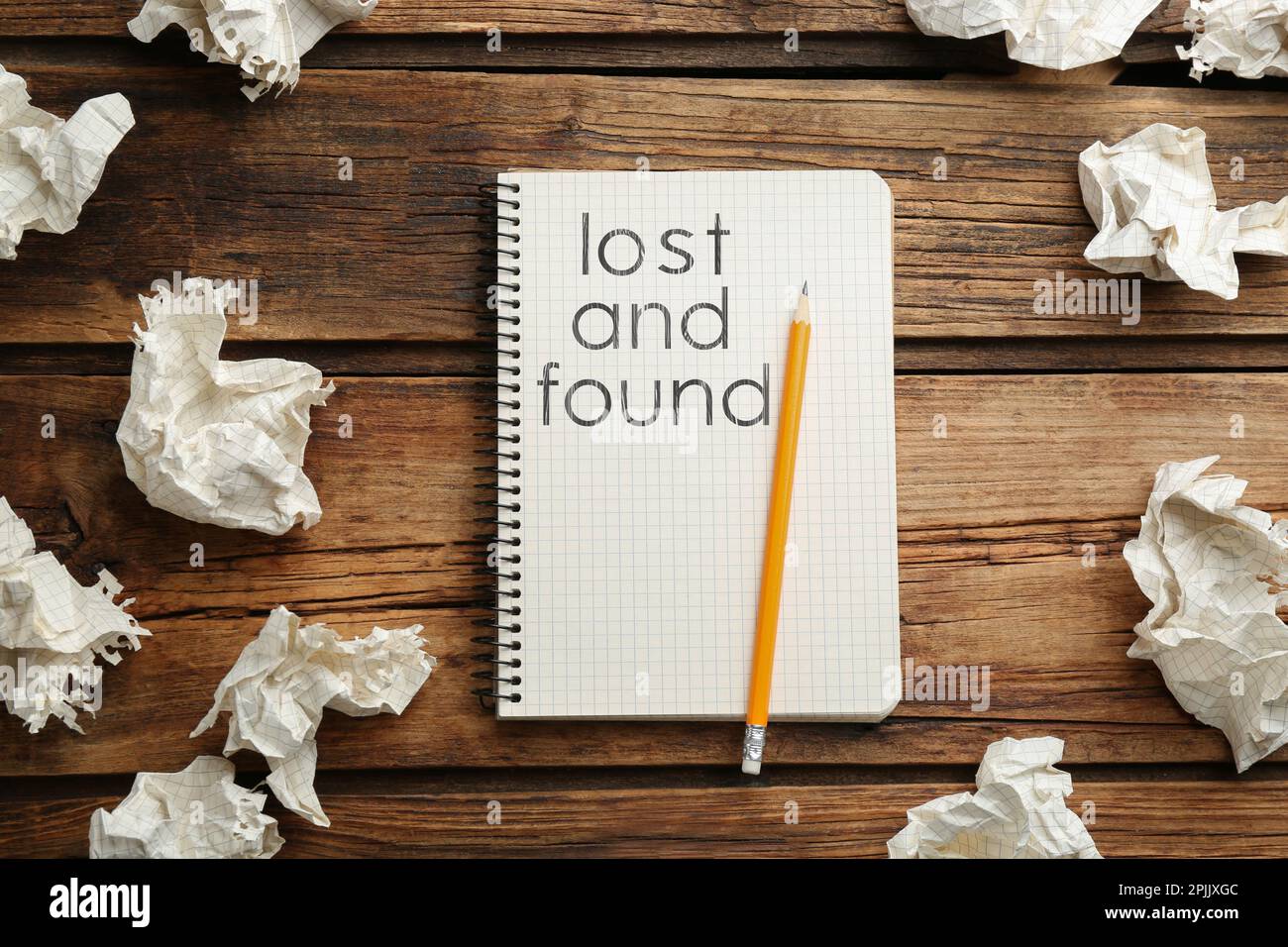 Notebook with phrase Lost and Found, pencil, crumpled sheets of paper ...
