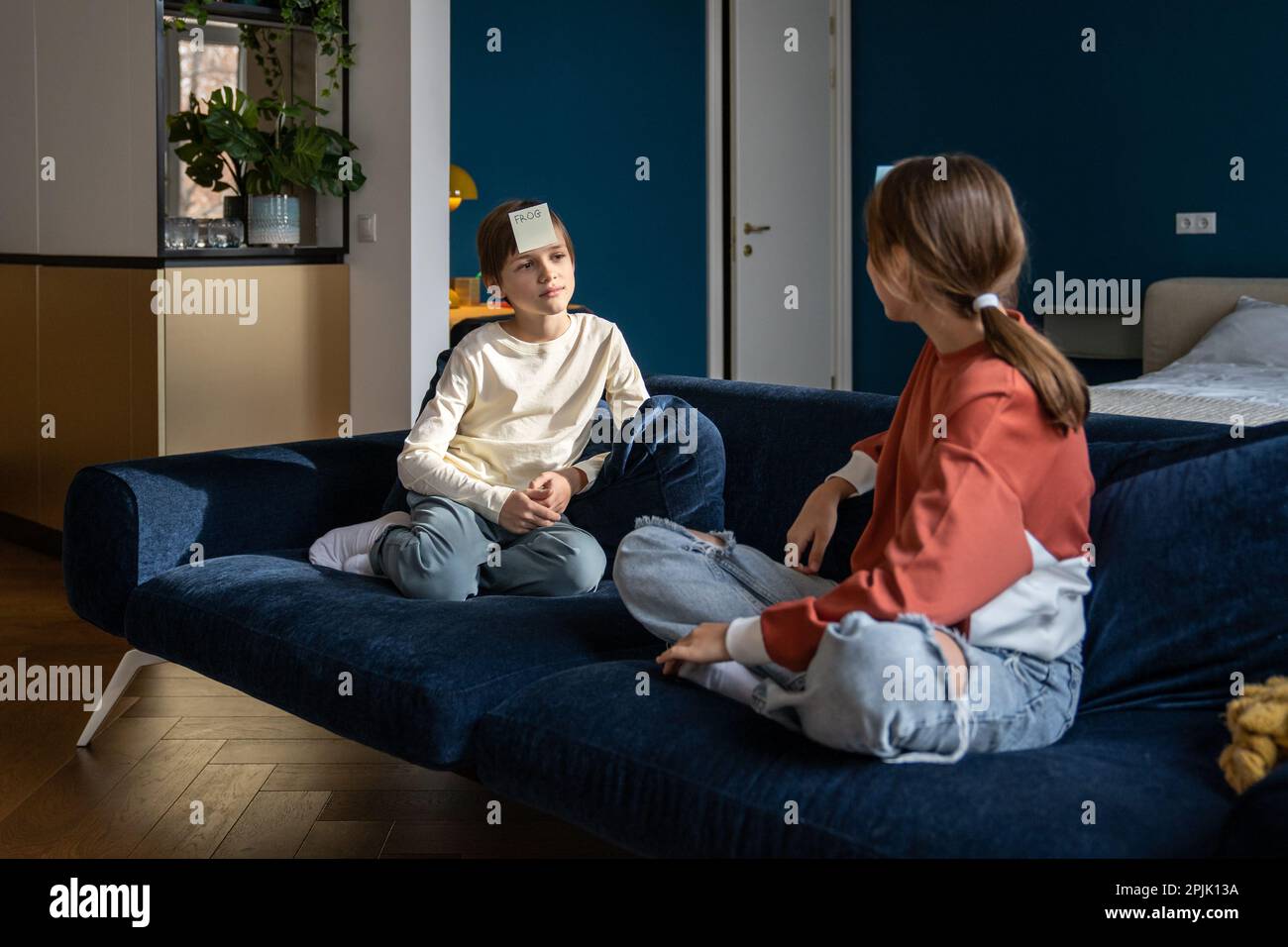 Two kids brother and sister playing guessing game Who am I at home ...