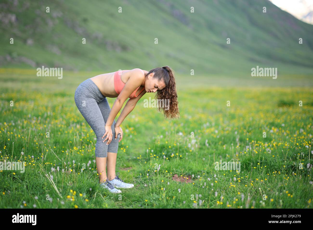 Exhausted runner in the mountain resting after sport Stock Photo - Alamy