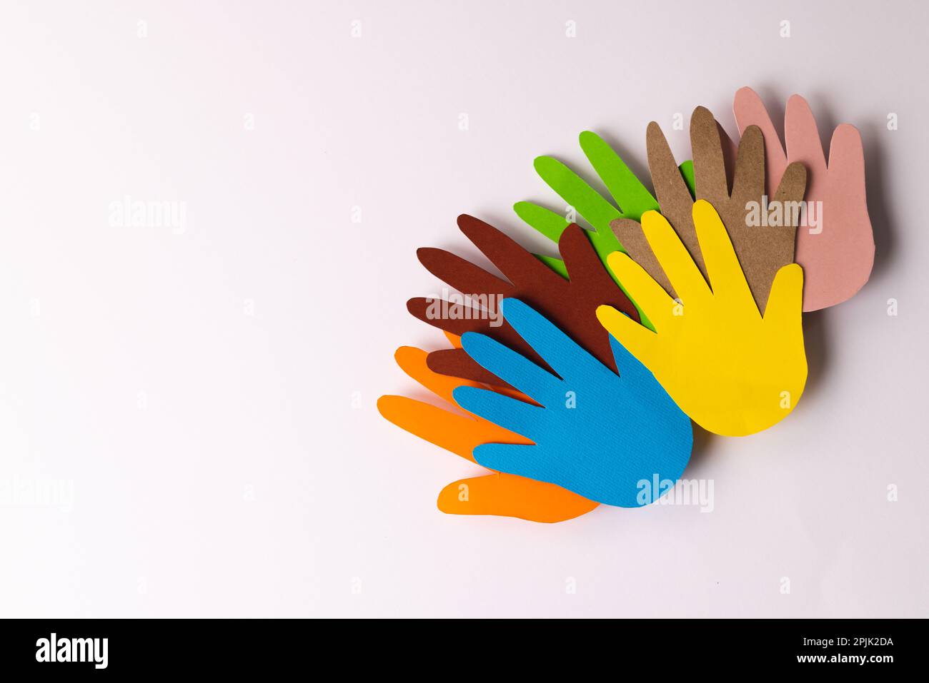 Close up of paper cut out of multi coloured hands with copy space on ...