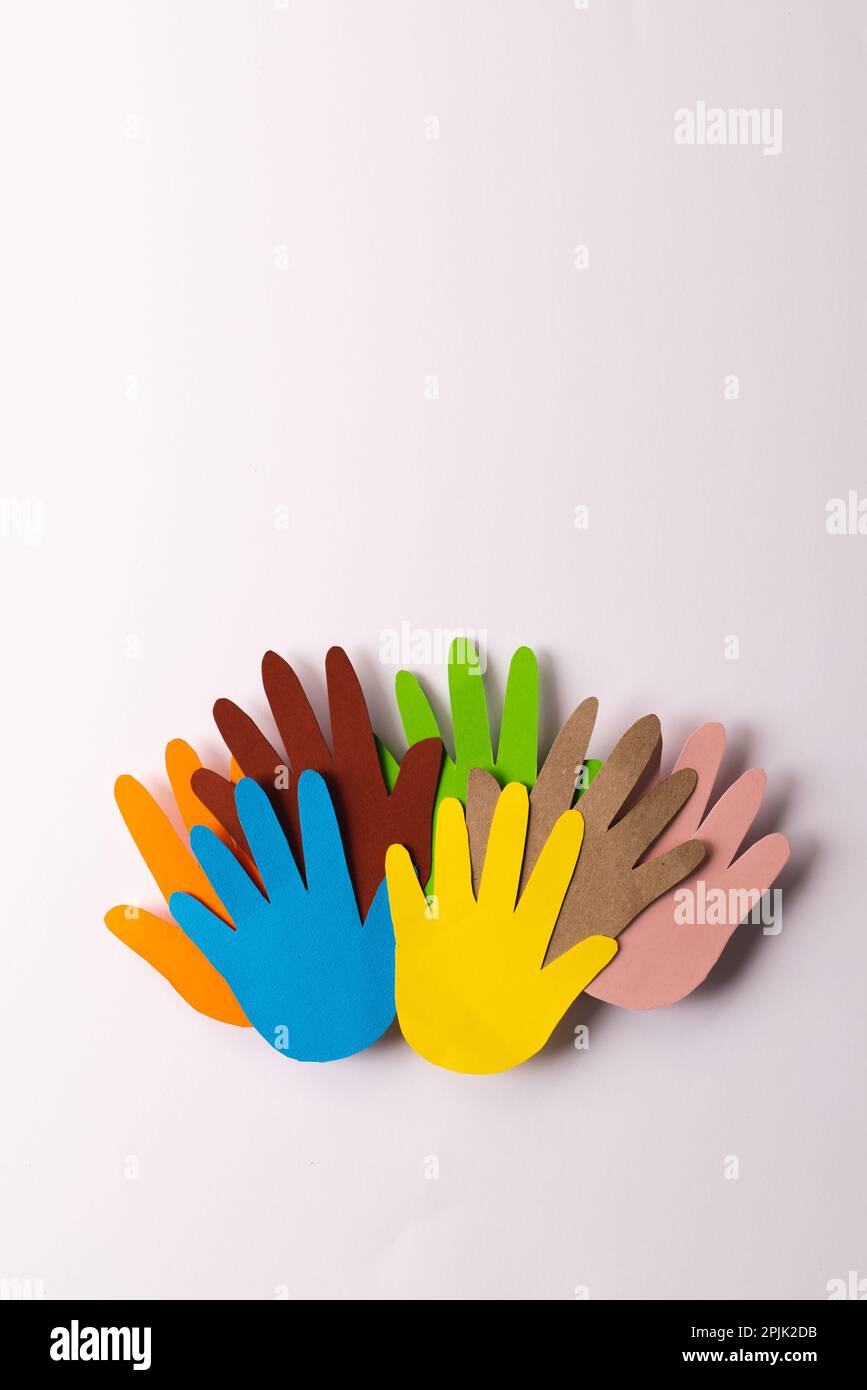 Close up of paper cut out of multi coloured hands with copy space on ...
