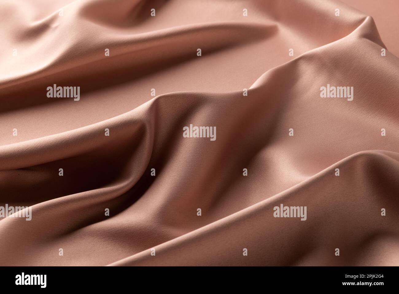 Close up of plain beige satin fabric with folds, copy space Stock Photo ...