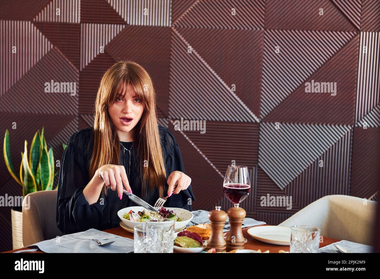 Girl tastes food. Indoors of new modern luxury restaurant Stock Photo ...