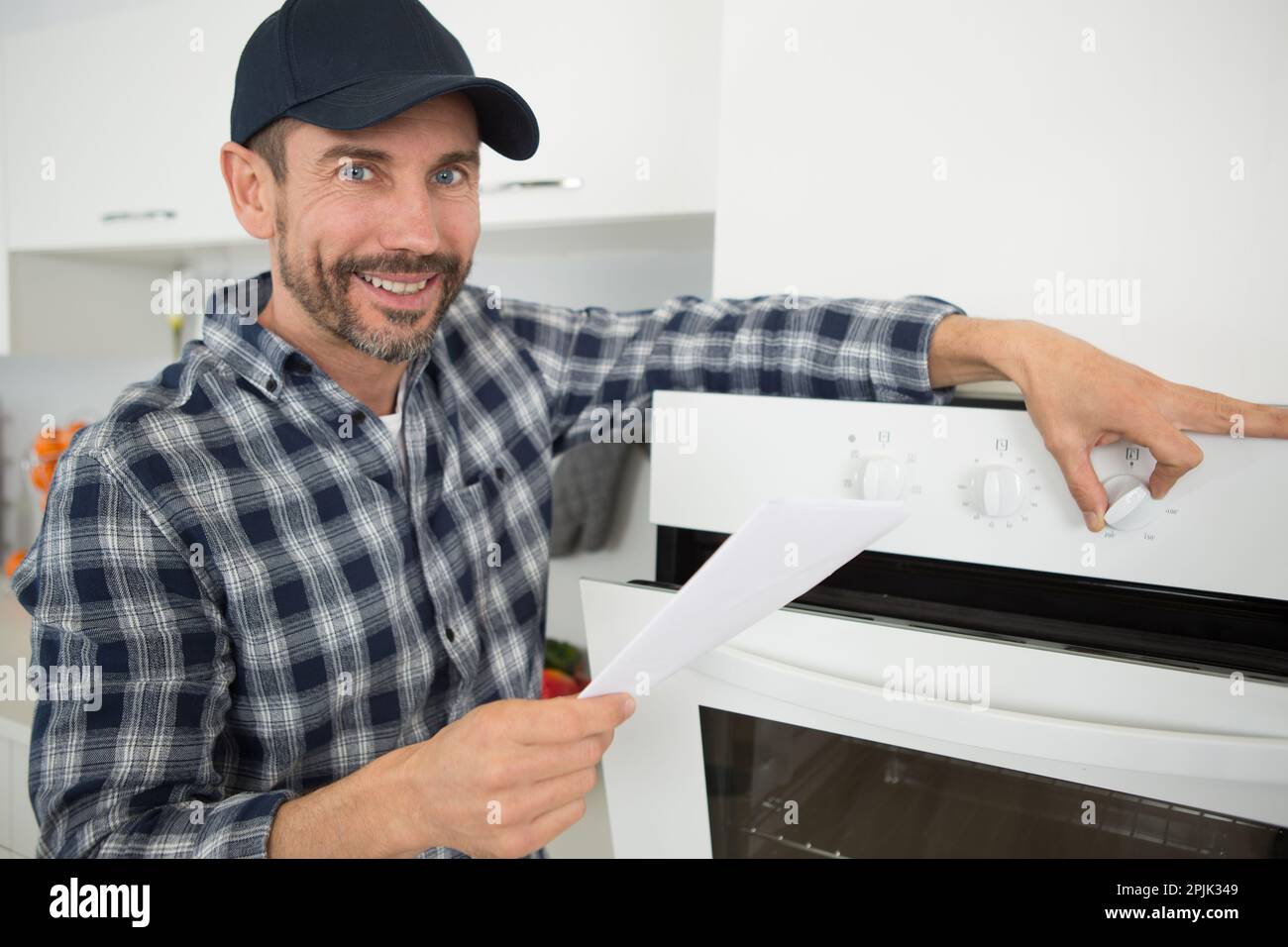 contractor reading instructions for new oven Stock Photo - Alamy