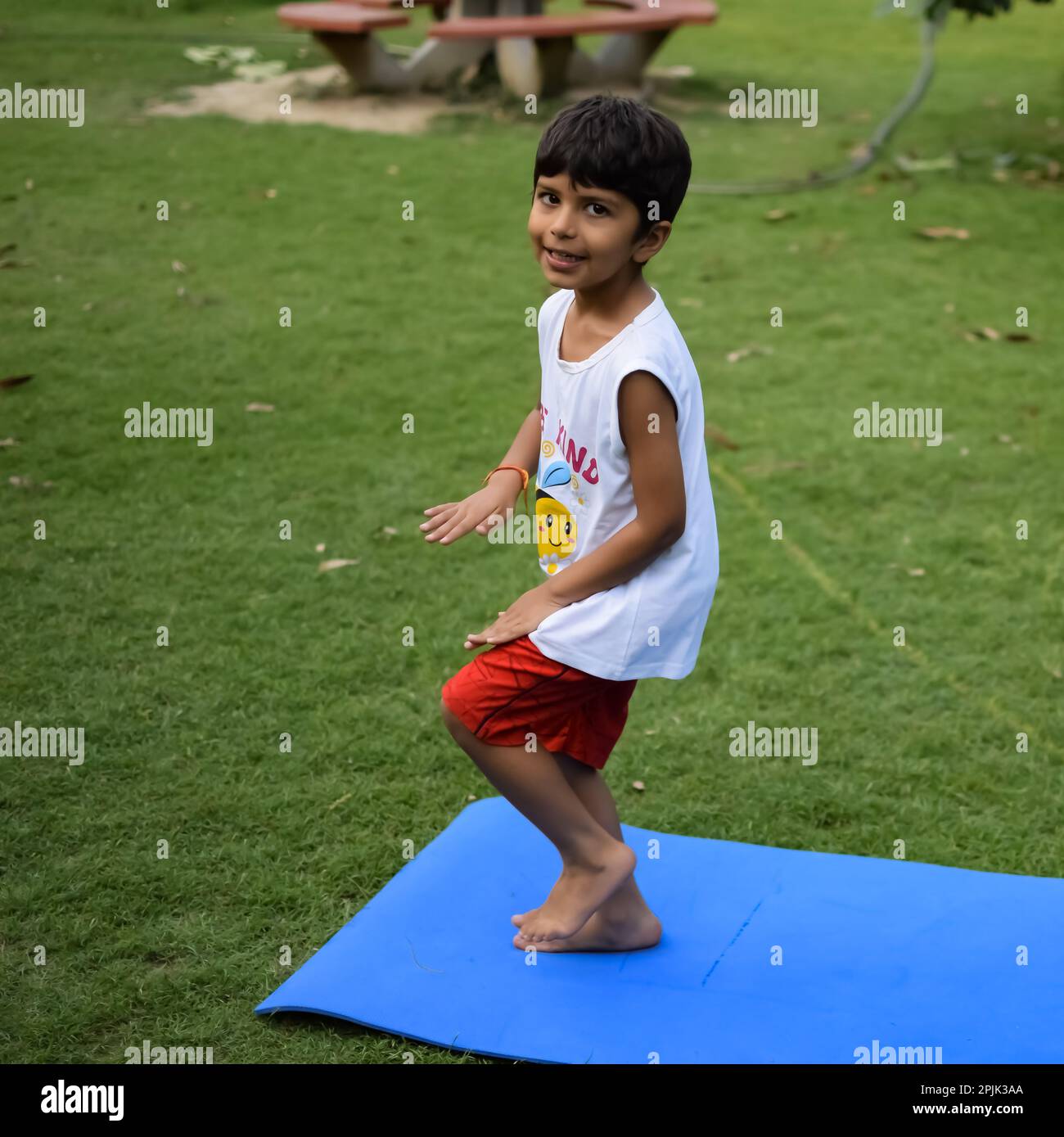 Asian smart kid doing yoga pose in the society park outdoor, Children's ...