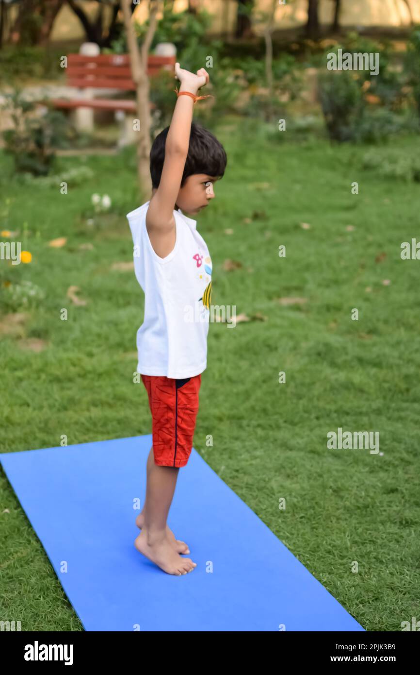 Asian smart kid doing yoga pose in the society park outdoor, Children's ...