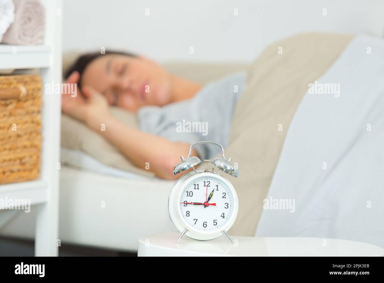 Woman setting alarm clock hi-res stock photography and images - Alamy