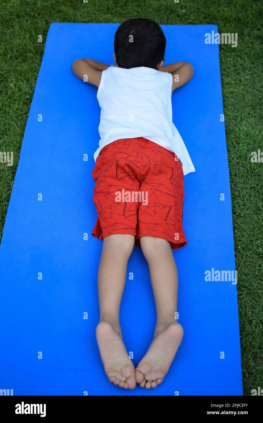 Asian smart kid doing yoga pose in the society park outdoor, Children's ...