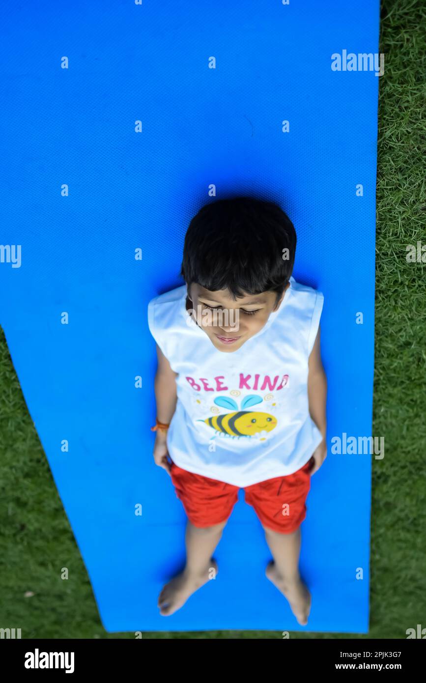 Asian smart kid doing yoga pose in the society park outdoor, Children's ...
