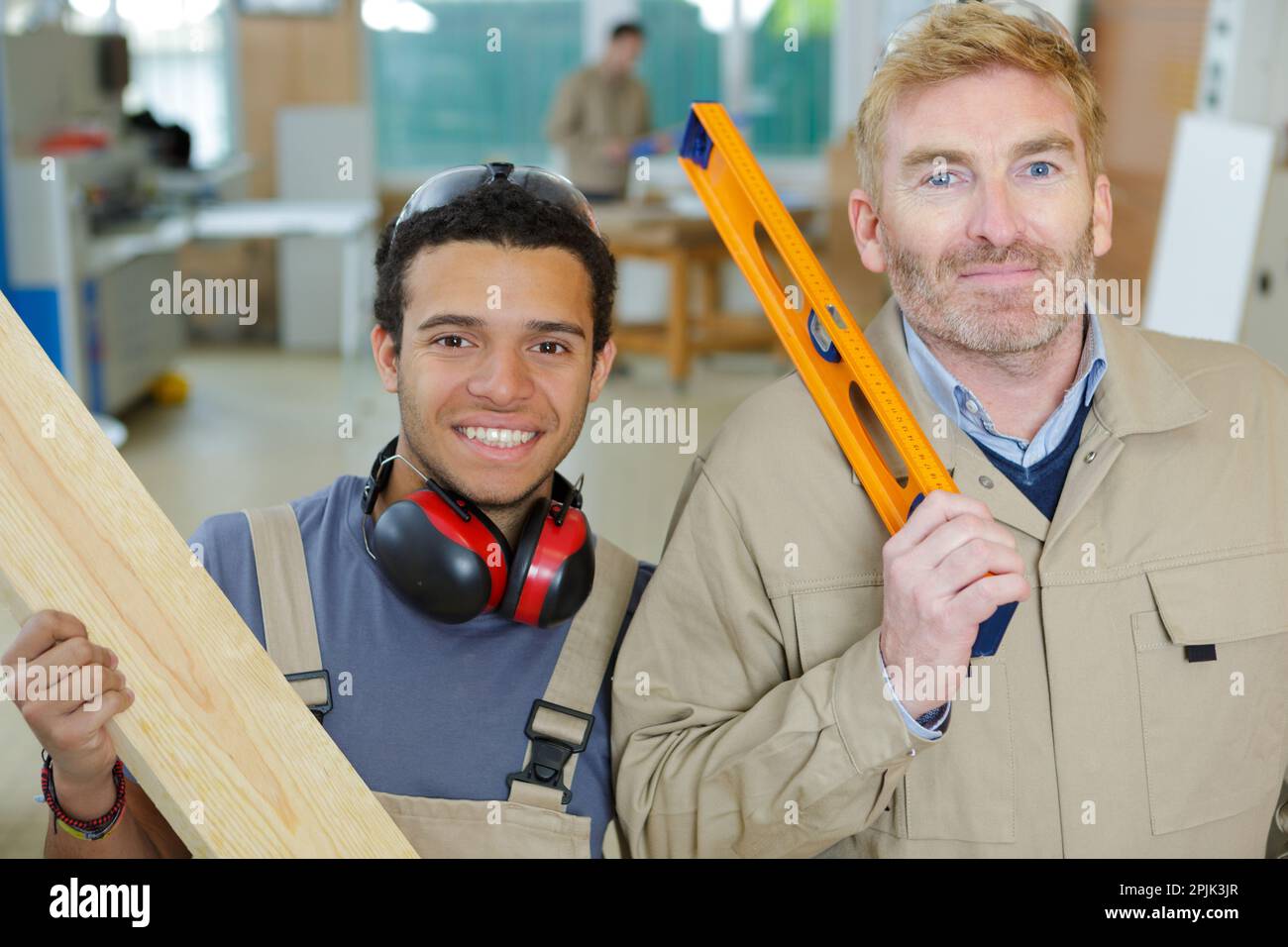 two men working together to build wooden frame Stock Photo - Alamy