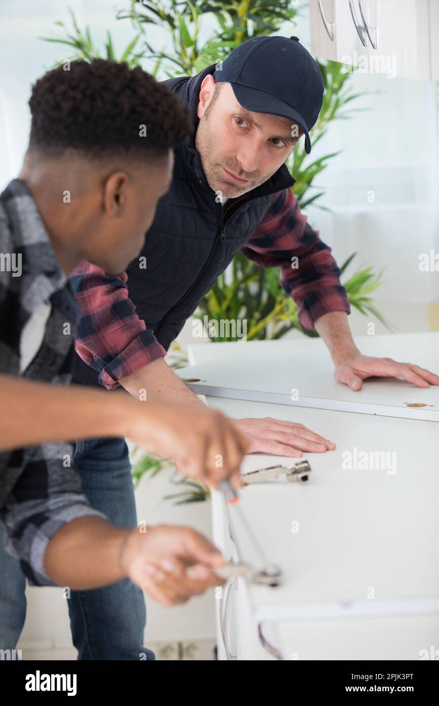 master and apprentice working indoors Stock Photo - Alamy