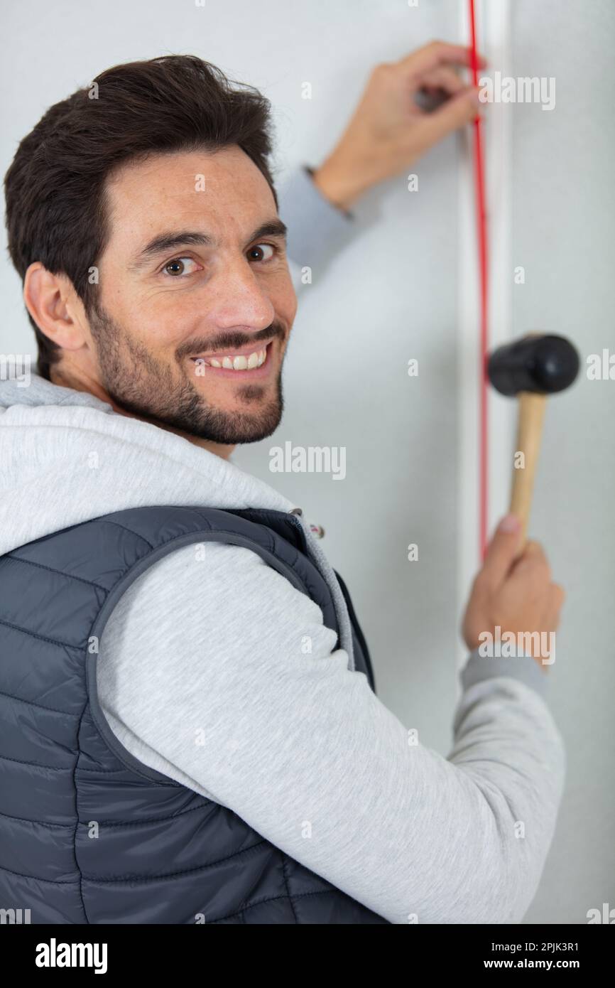 young professional fixing indoor wiring in new building Stock Photo - Alamy
