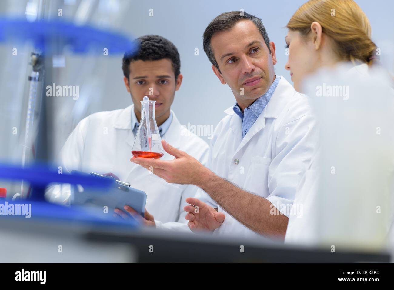 a lab worker with students Stock Photo - Alamy