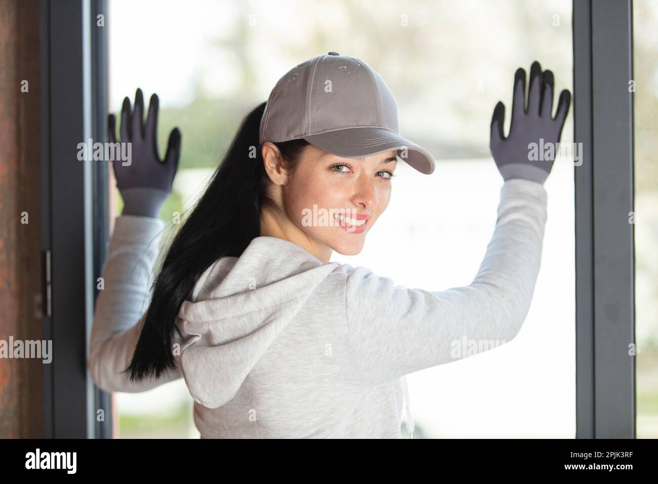 female builder installing a window Stock Photo - Alamy