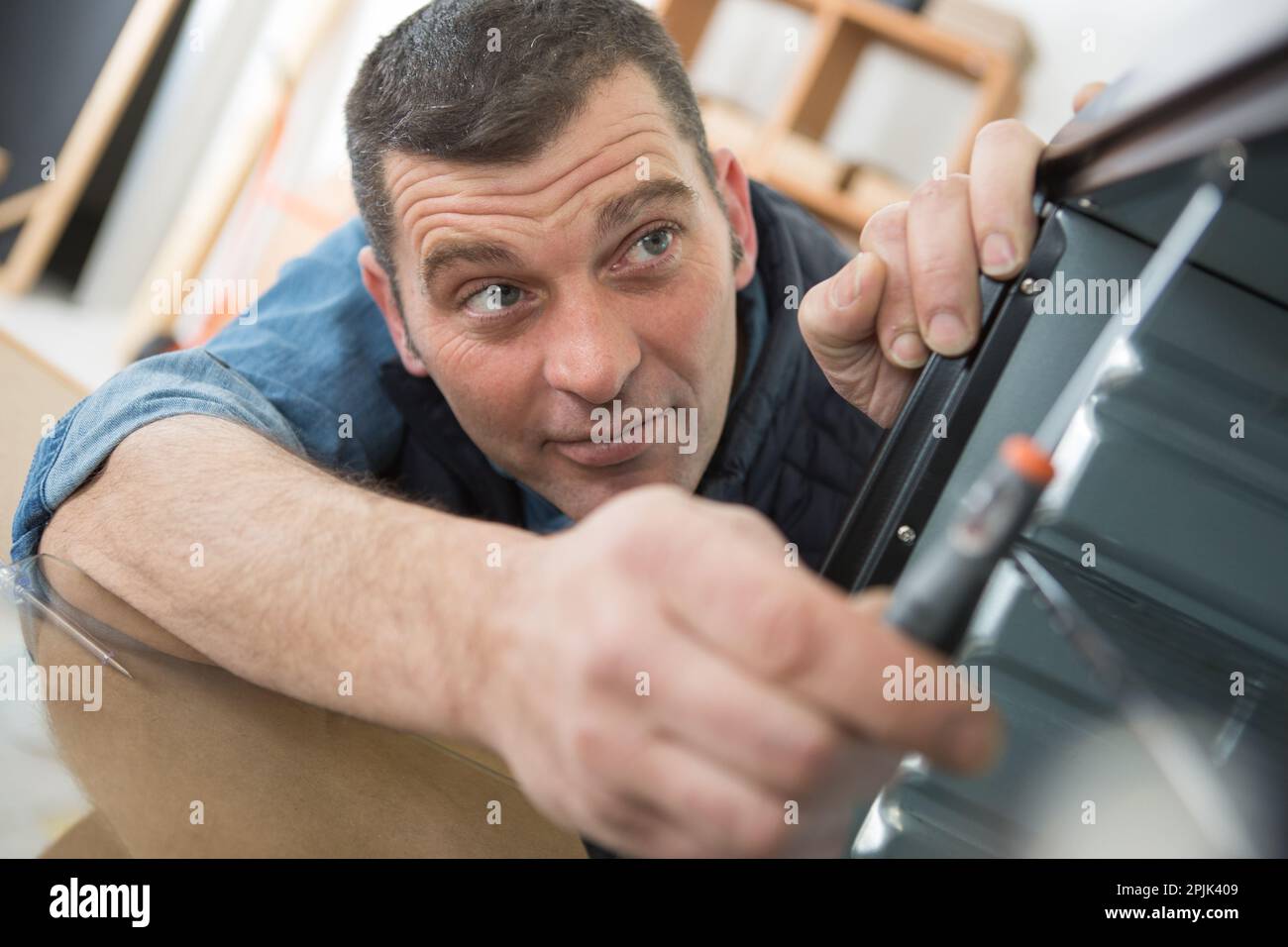 workman assembling an electric oven Stock Photo - Alamy