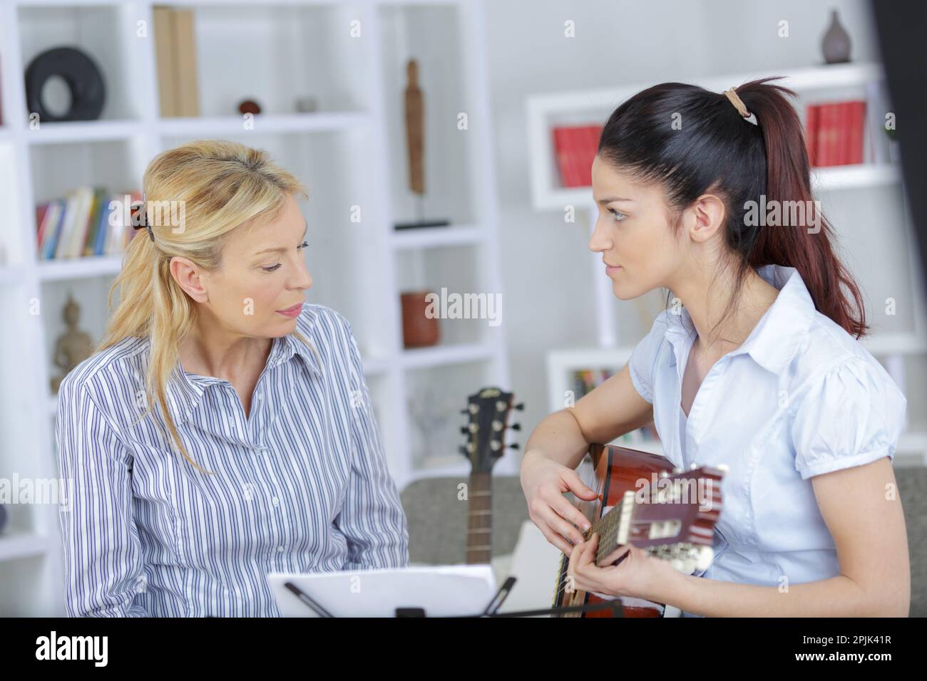 Girl composes music guitar hi-res stock photography and images - Alamy