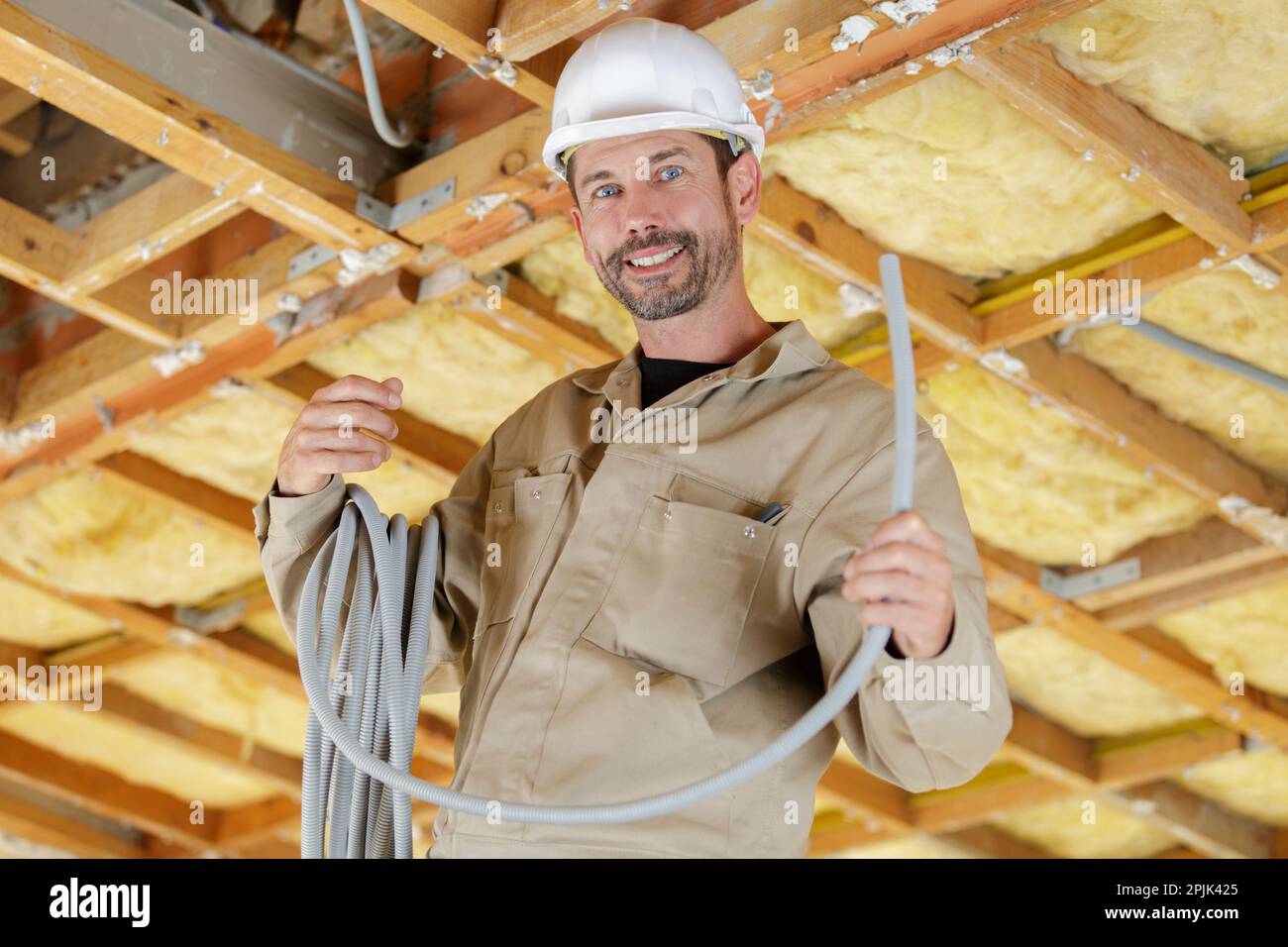 handsome man electrician wiring cable Stock Photo - Alamy