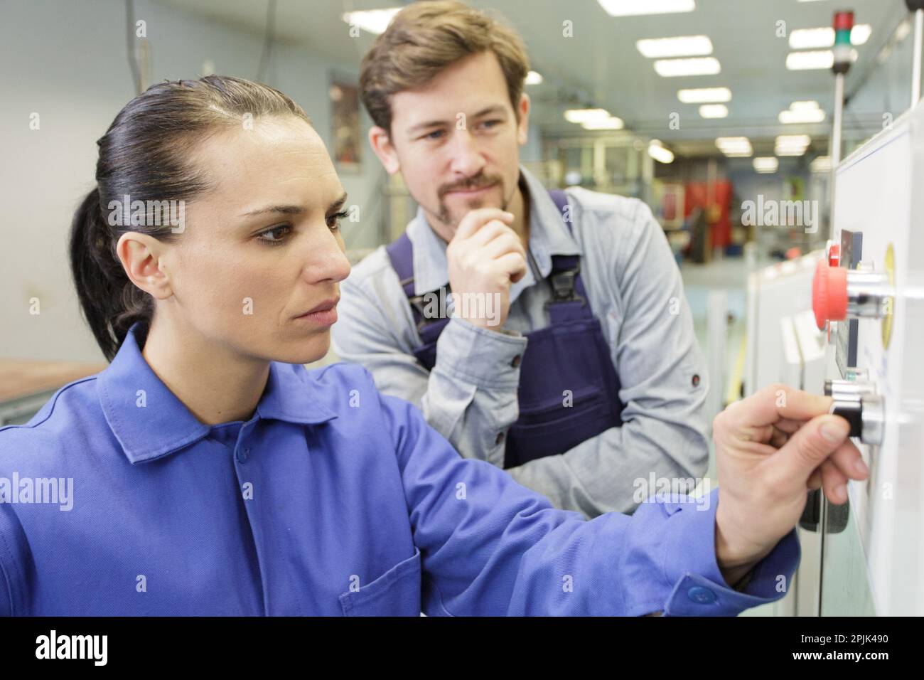supervisor watching female worker using machinery control panel Stock ...
